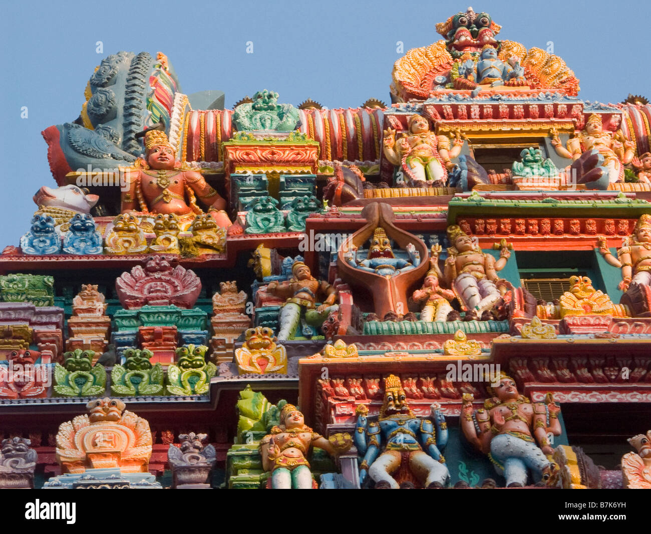 Colorful imagery from Hindu mythology atop a tower at a Hindu temple ...