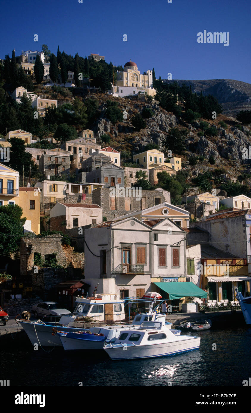 Harbour Boats moored at edge of sea Buildings on slope behind SIMI TOWN ...
