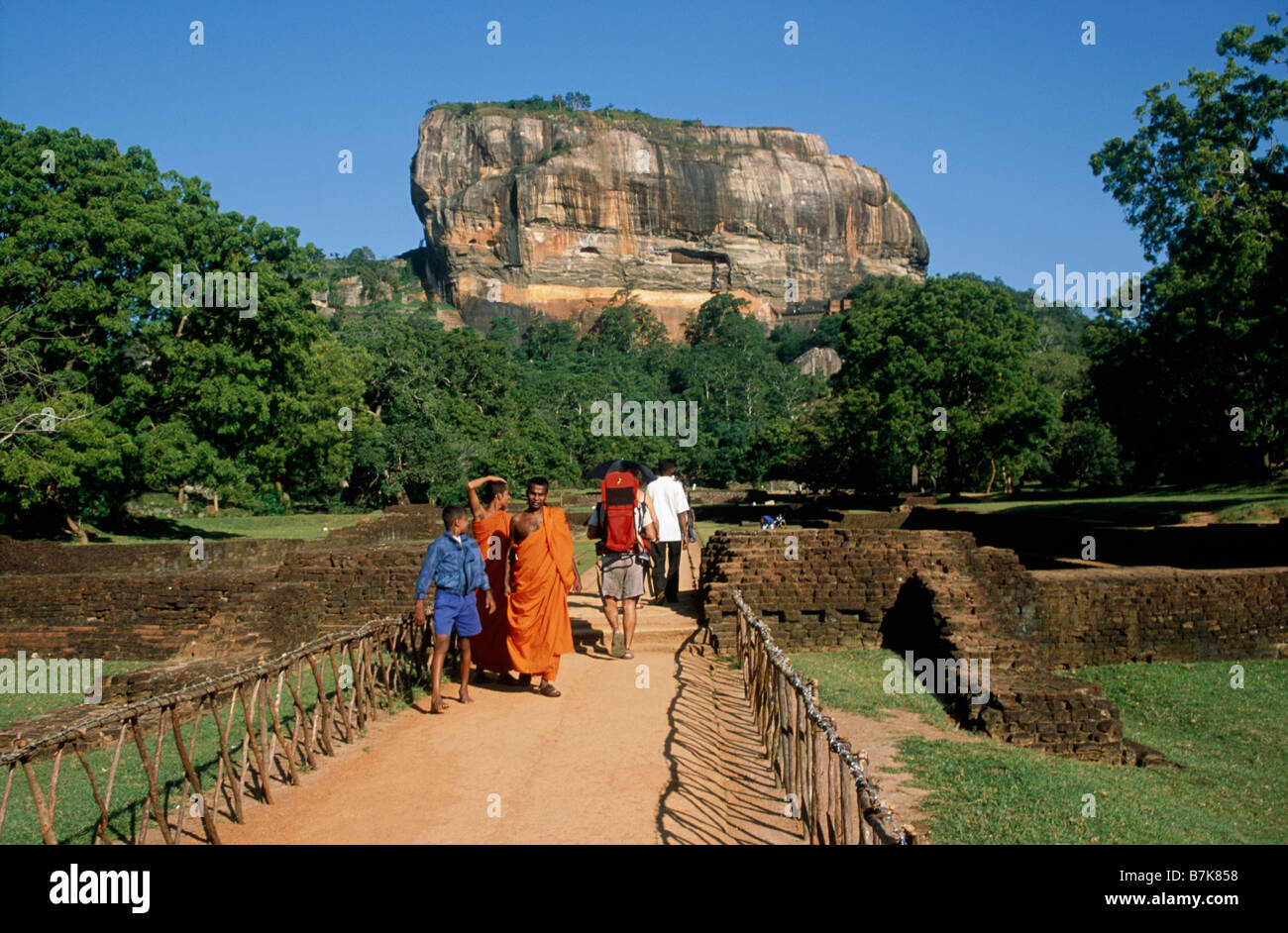 Rock formation fortress Two Buddhist monks Man with rucksack SIGIRIYA ...