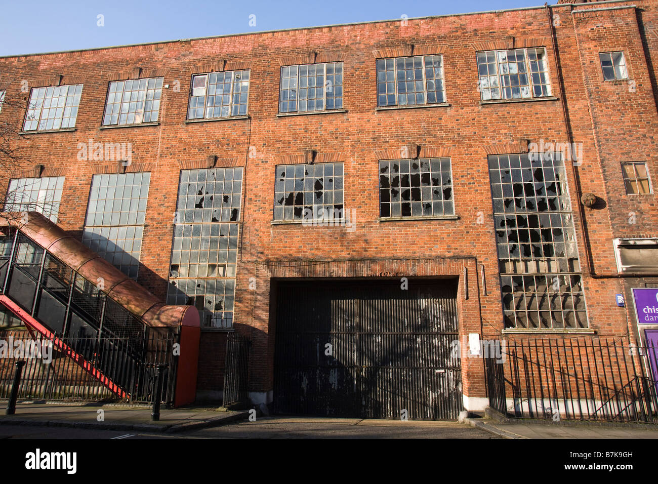 Shattered glass windows in Derelict factory, Tower Hamlets London GB UK ...