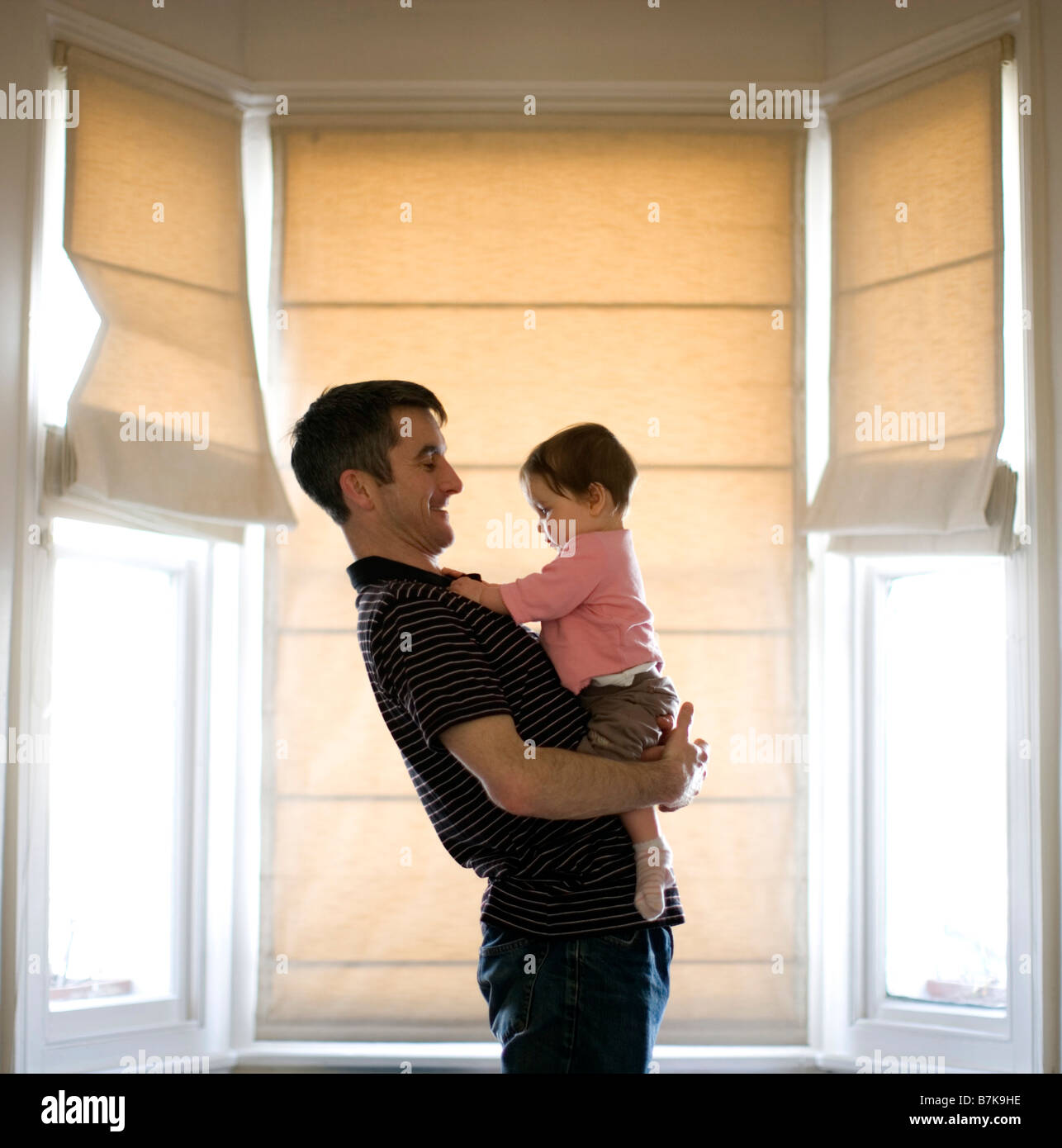 A proud father holds his baby daughter Stock Photo - Alamy