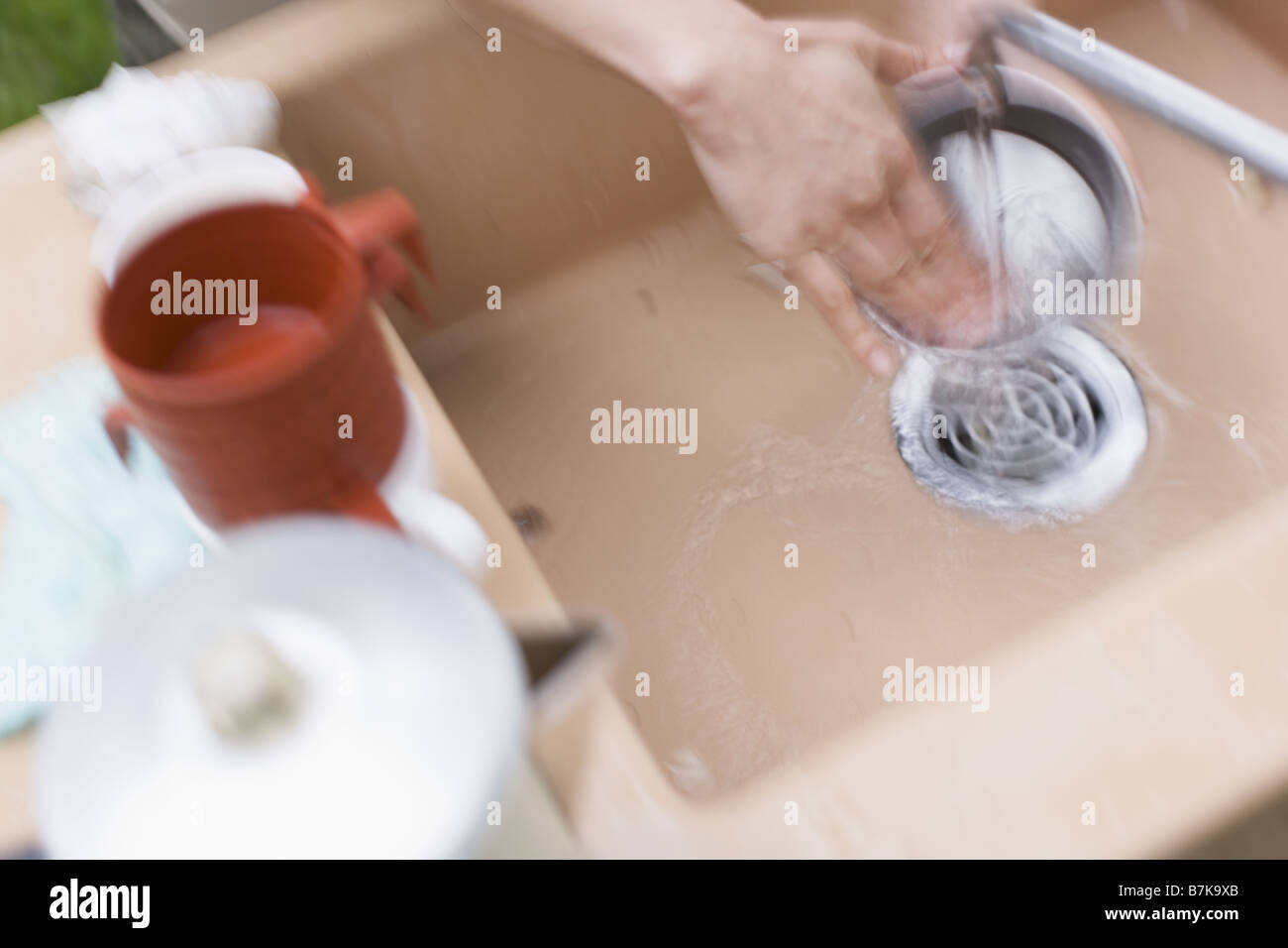 Woman Washing Utensils Stock Photo - Alamy