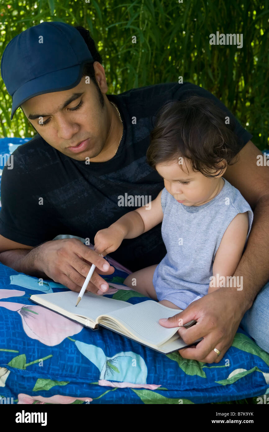 hispanic father and baby son drawing while enjoying the summer in the ...