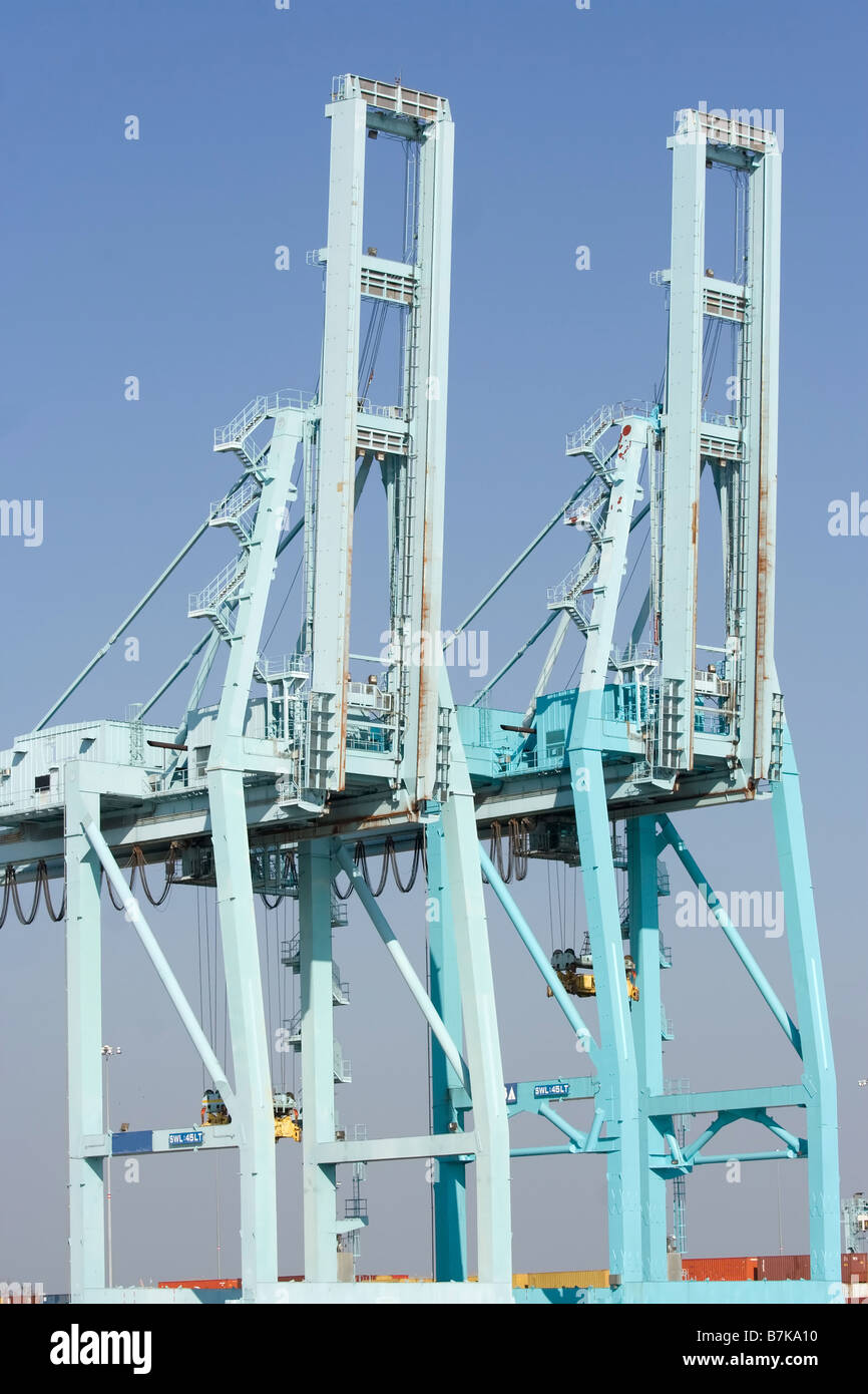 pair of port container cranes against blue sky Stock Photo - Alamy