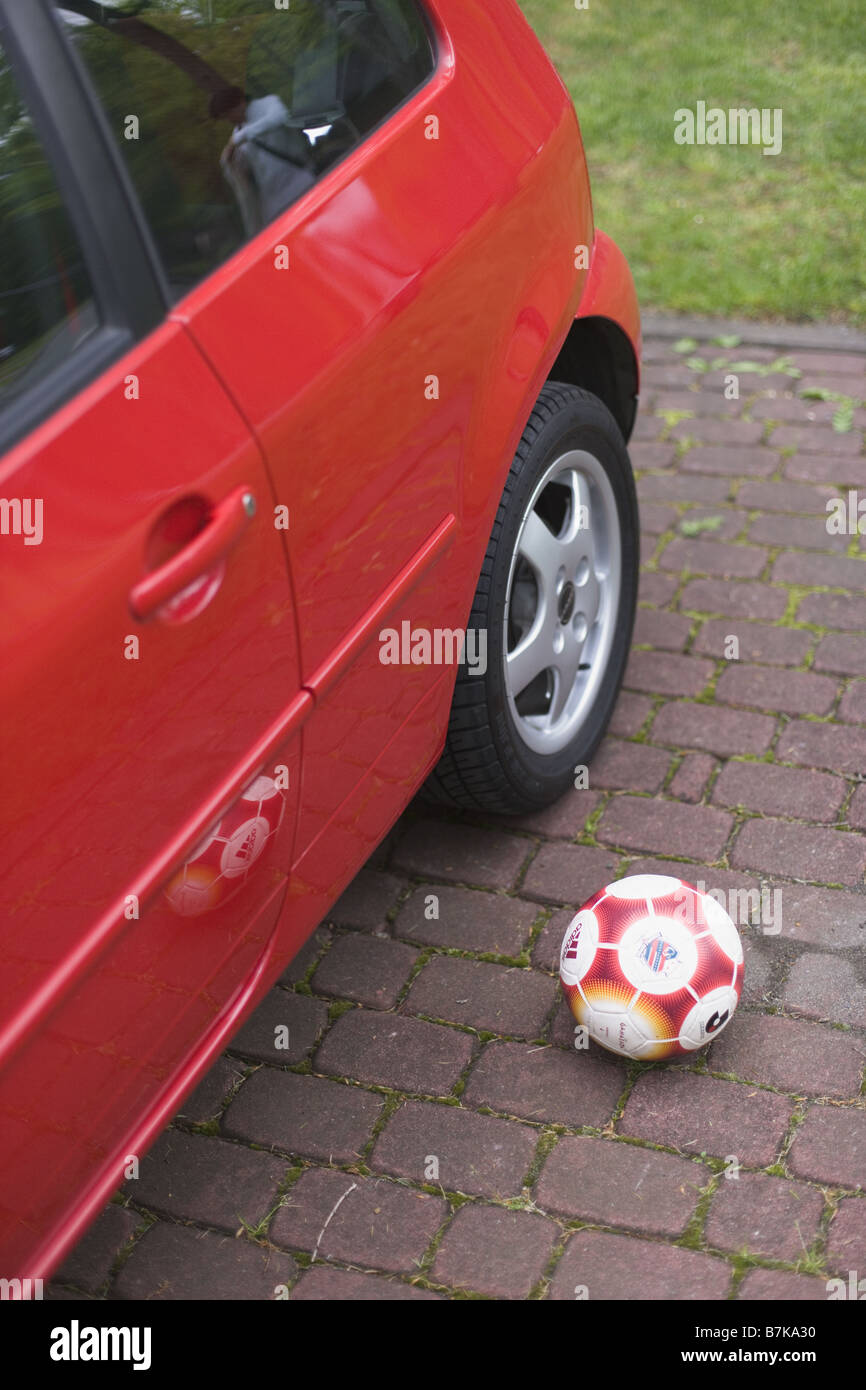 Soccer Ball and Red Car Stock Photo - Alamy