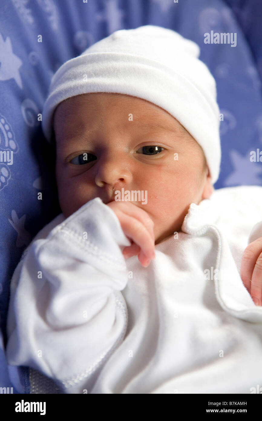 A newborn baby girl with a hat on Stock Photo - Alamy