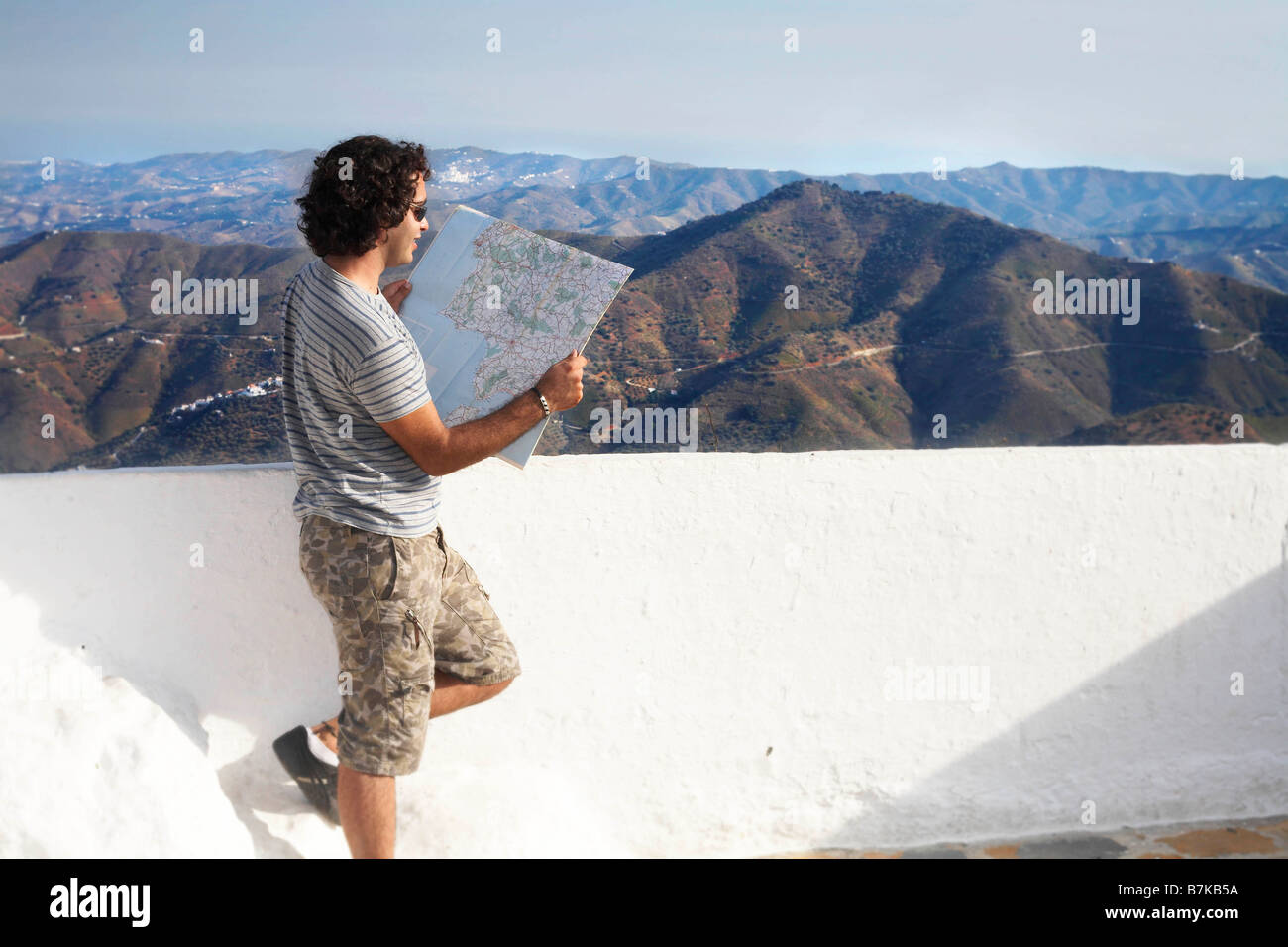 Man looking at a map Stock Photo - Alamy
