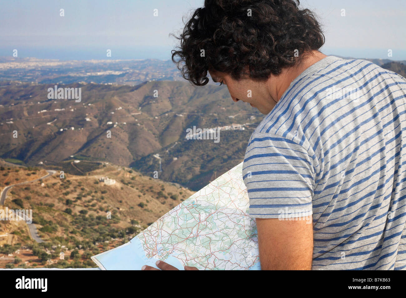 Man looking at a map Stock Photo - Alamy