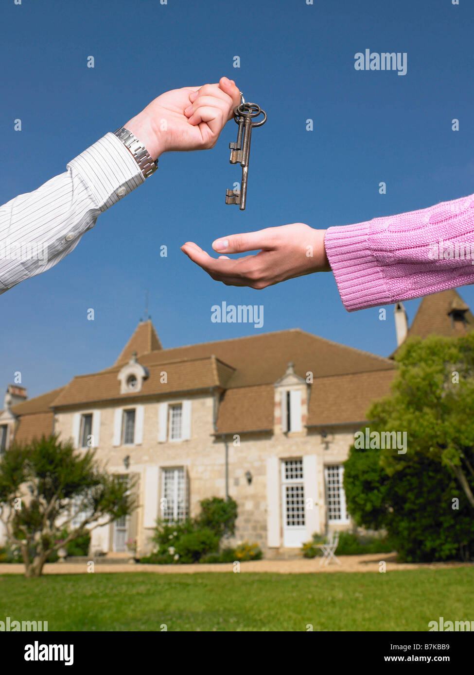 Woman receiving keys to country home Stock Photo - Alamy