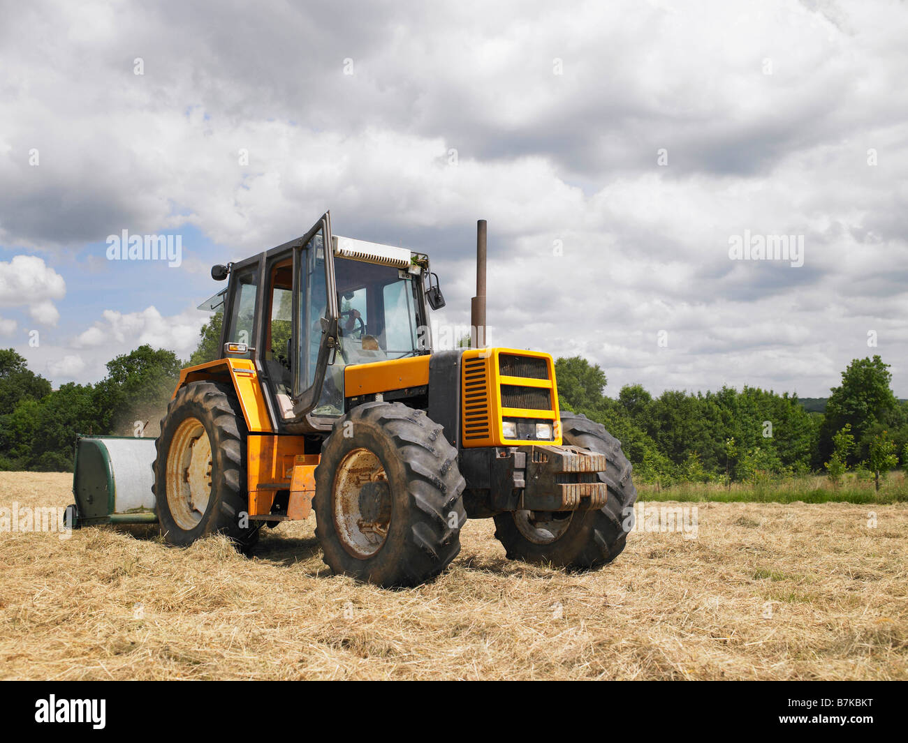man driving tractor Stock Photo - Alamy