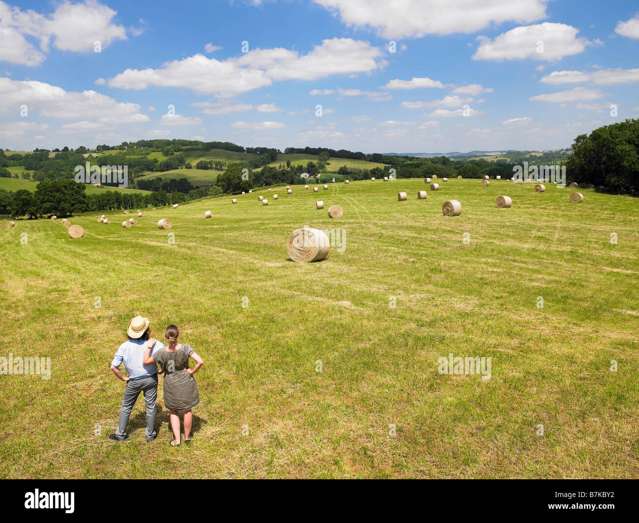 Man and woman standing in field Stock Photo - Alamy
