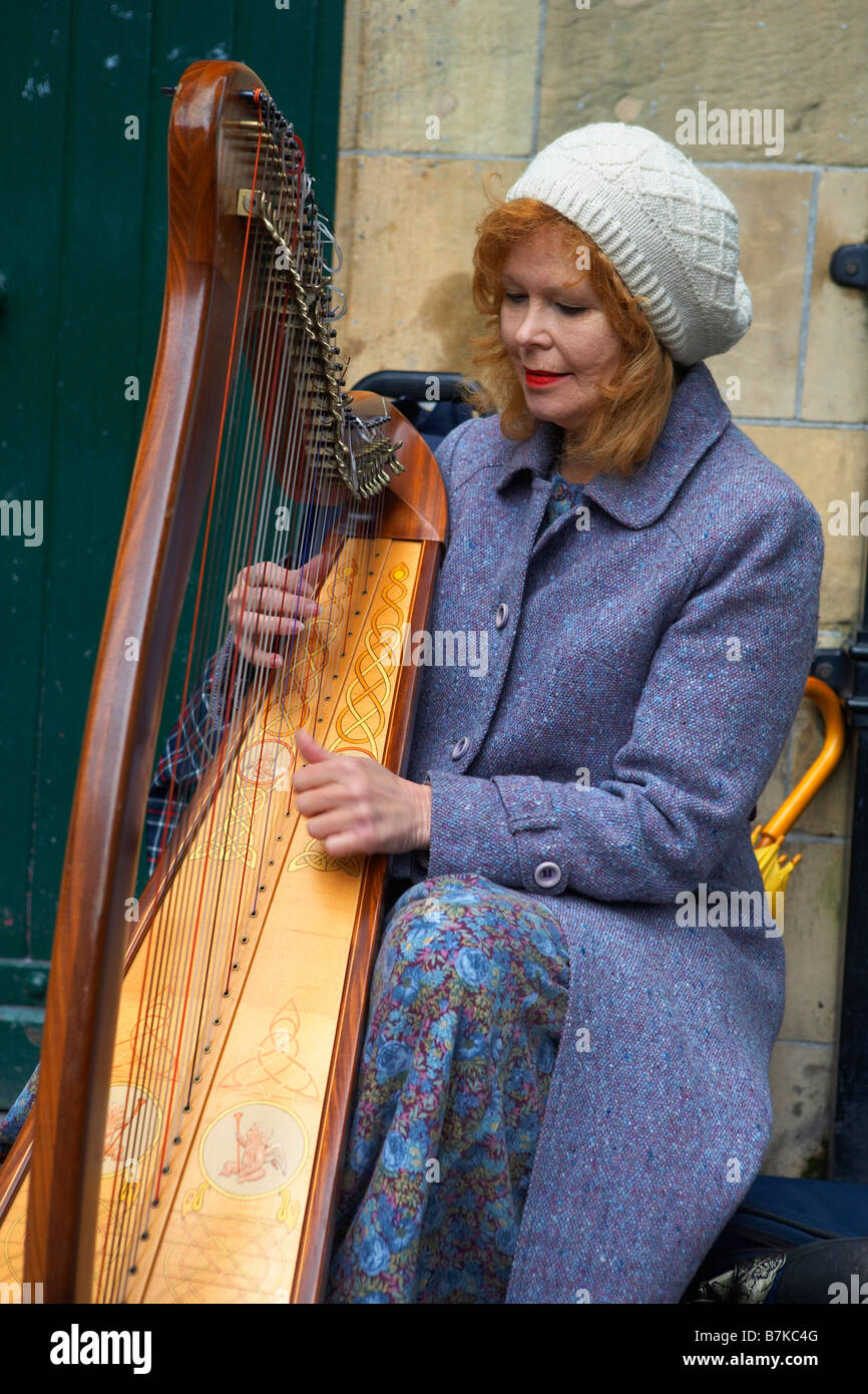 Redhaired woman playing Harp. Dublin, Ireland Stock Photo - Alamy