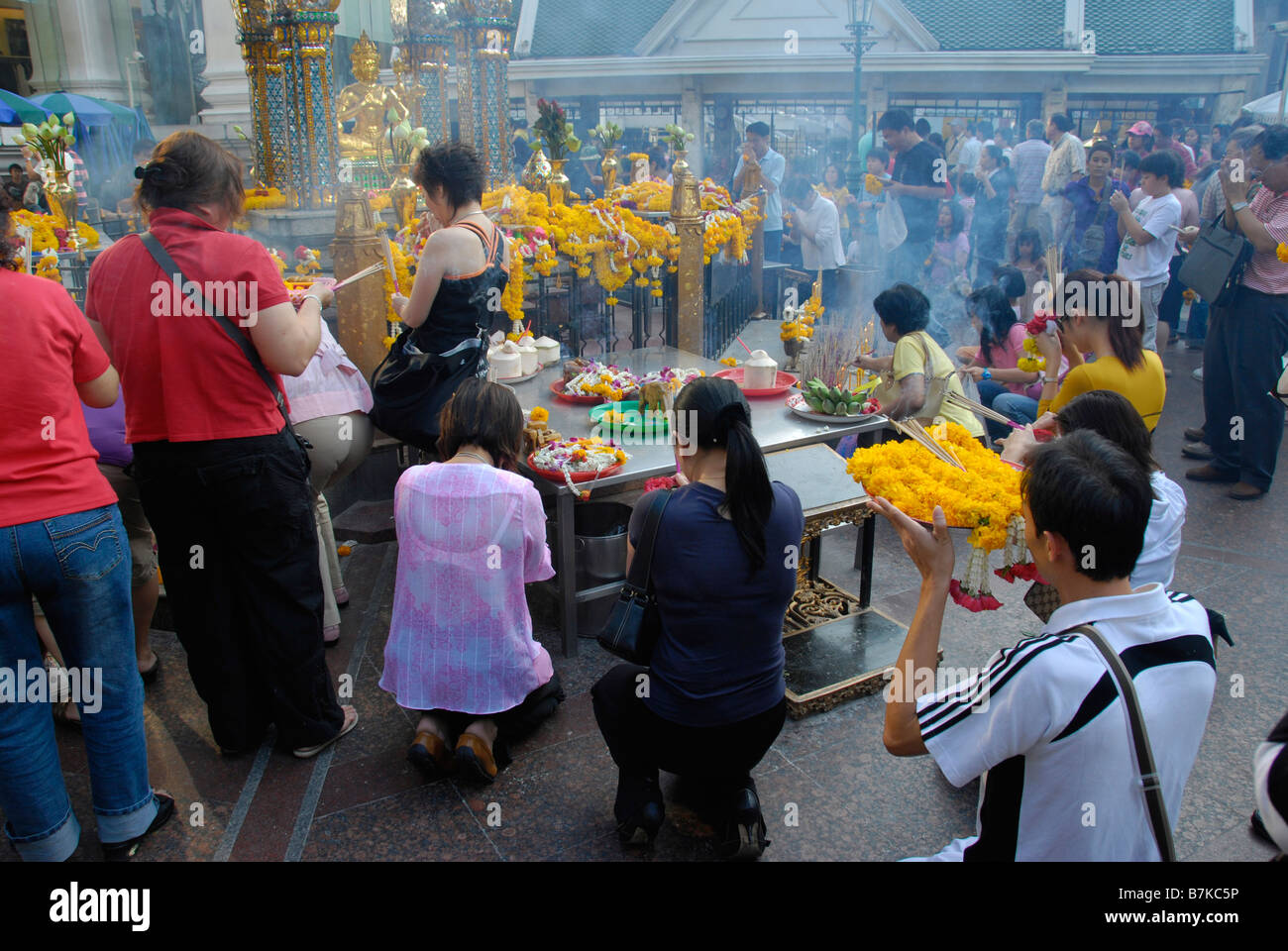 Crowd of Common People Devotees praying and worshipping gods in Bangkok ...