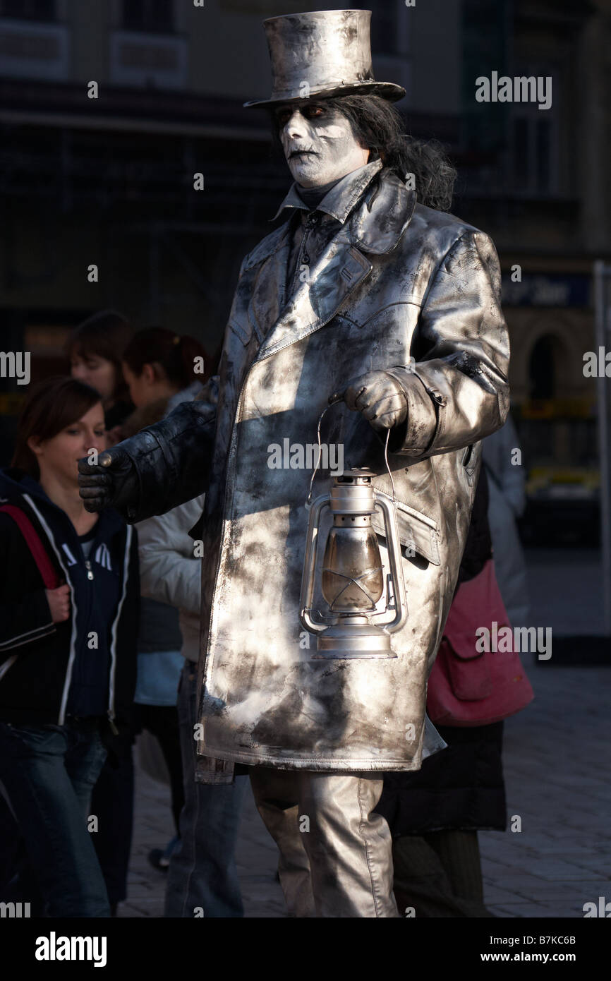Silver painted street performer in hi-res stock photography and images ...