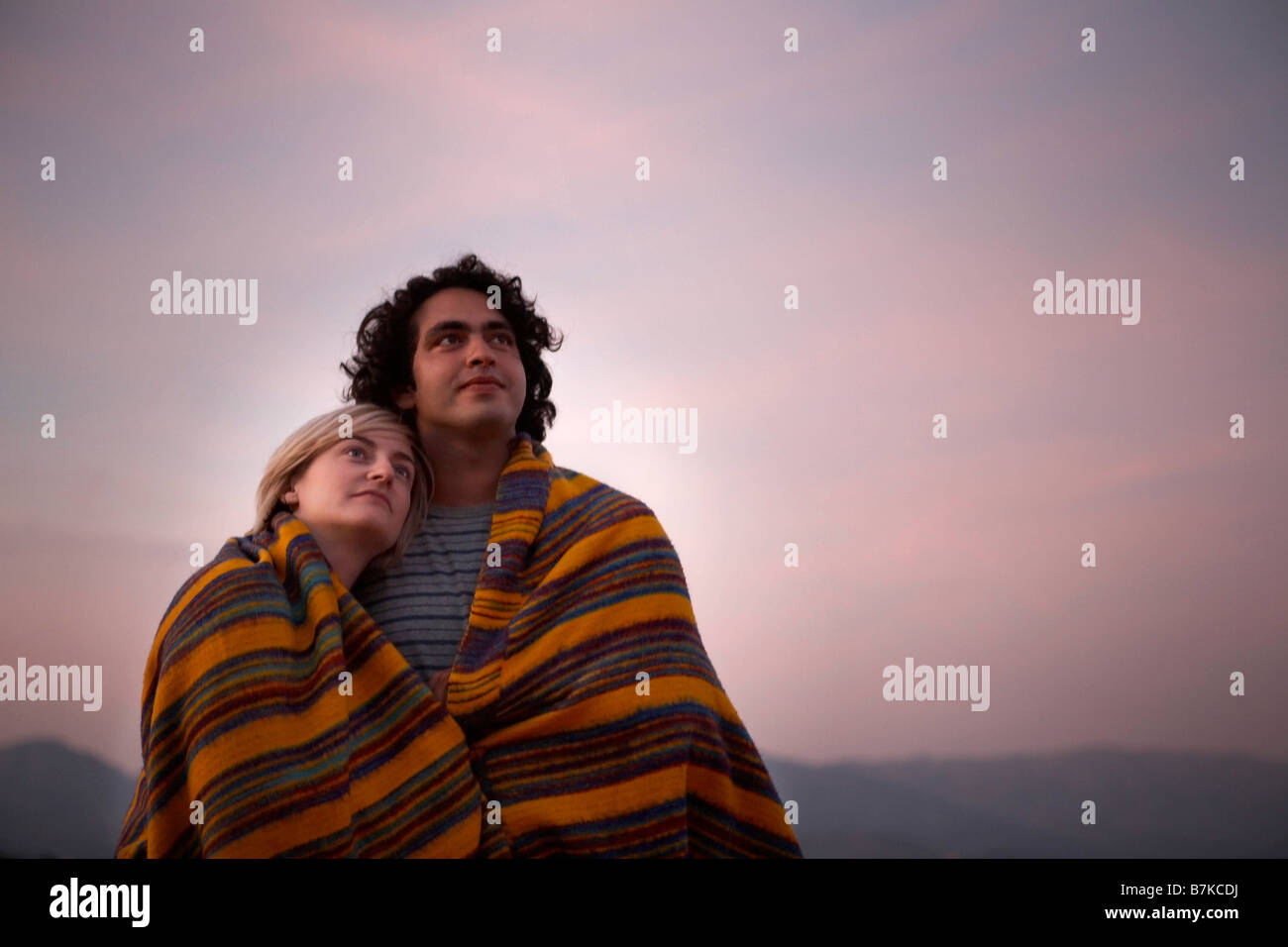 couple sharing a blanket Stock Photo - Alamy