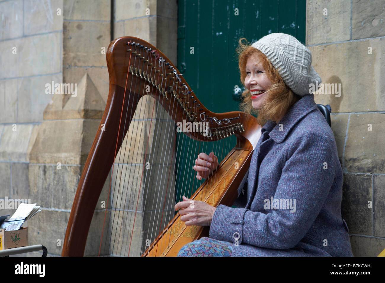 Redhaired woman playing Harp. Dublin, Ireland Stock Photo - Alamy