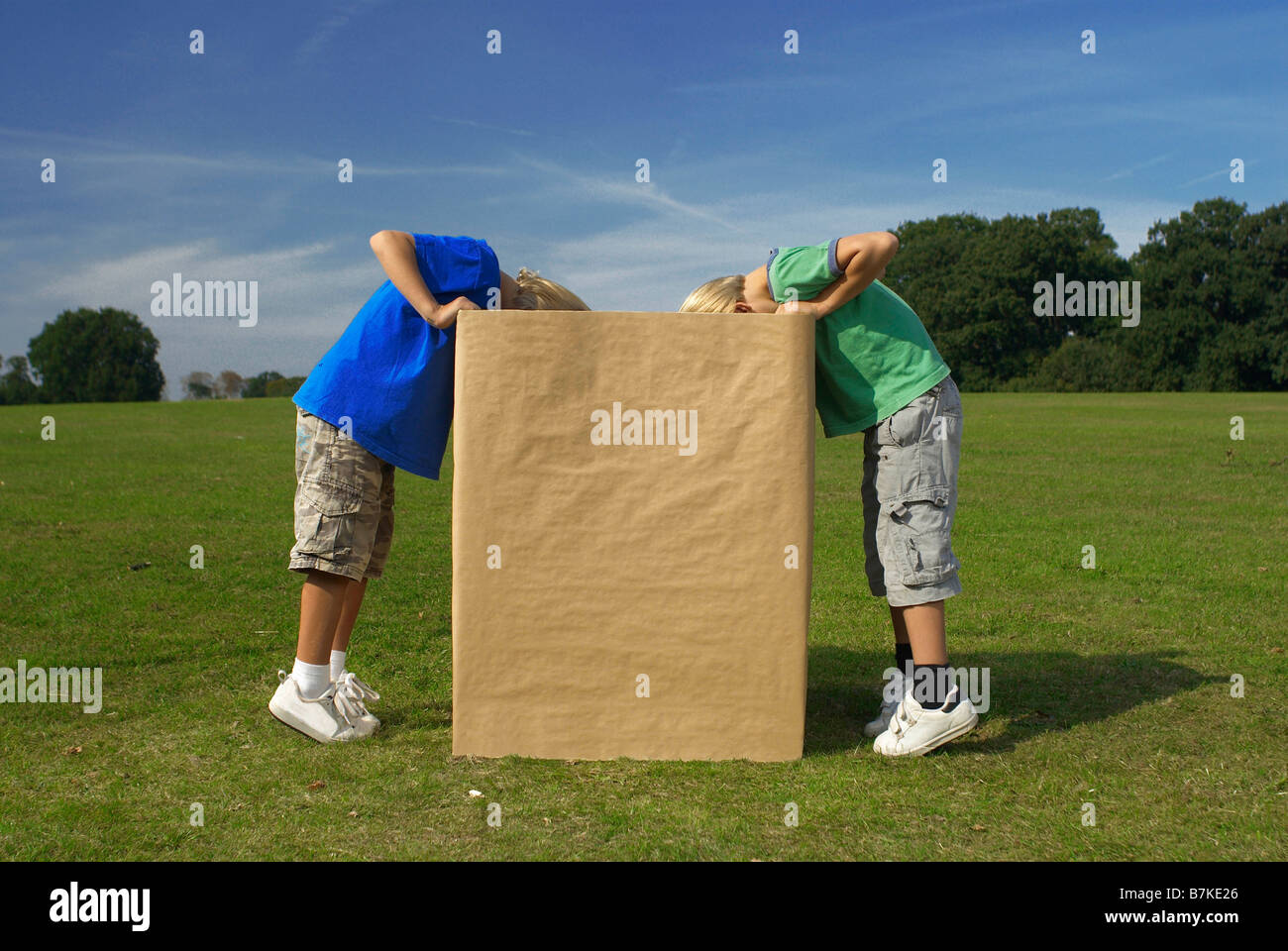two boys looking into box Stock Photo - Alamy