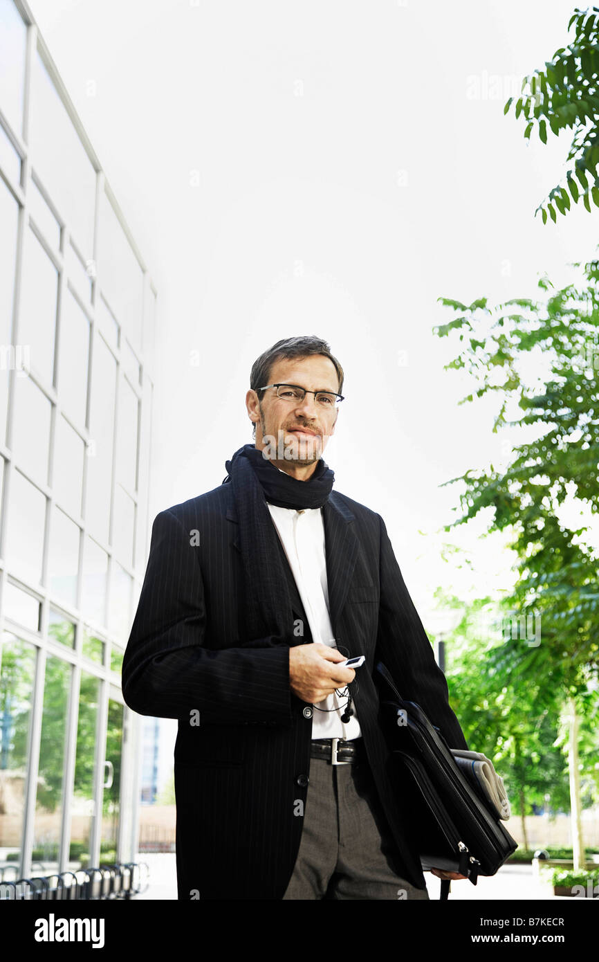 Man standing in front of building Stock Photo - Alamy