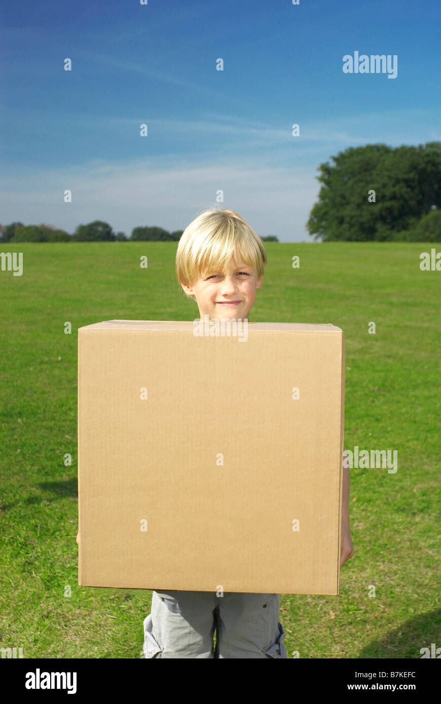 young boy holding box to camera Stock Photo - Alamy
