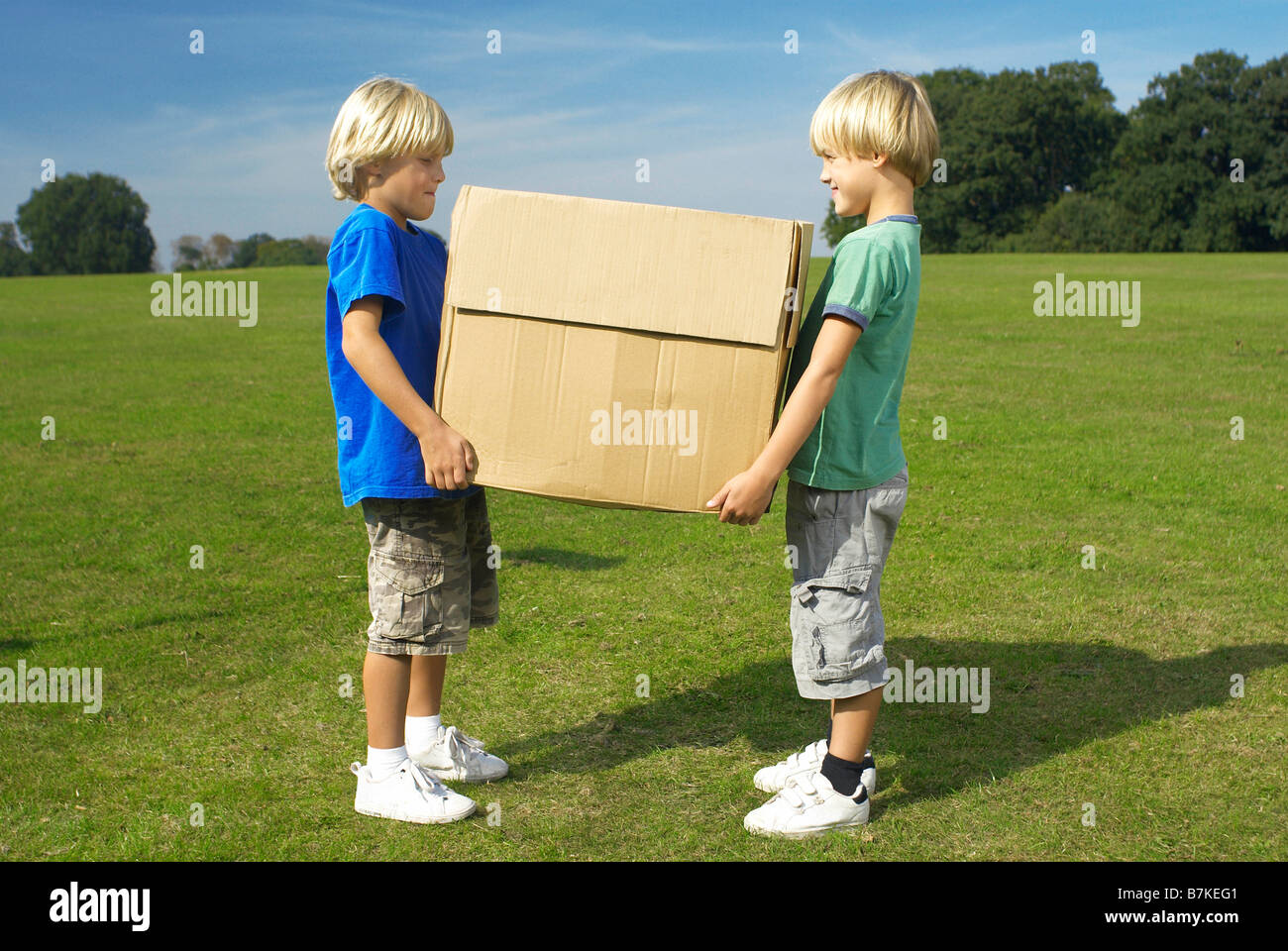 two boys holding box Stock Photo - Alamy