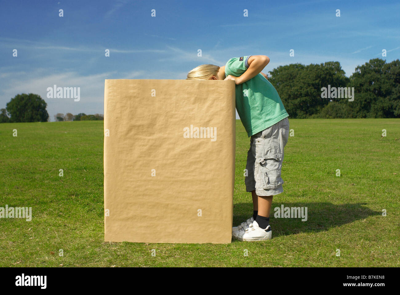 boy looking into box Stock Photo - Alamy