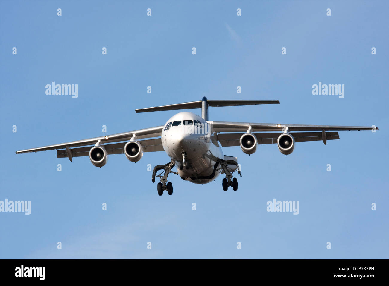 small four engine jet aircraft on final approach to land Stock Photo ...