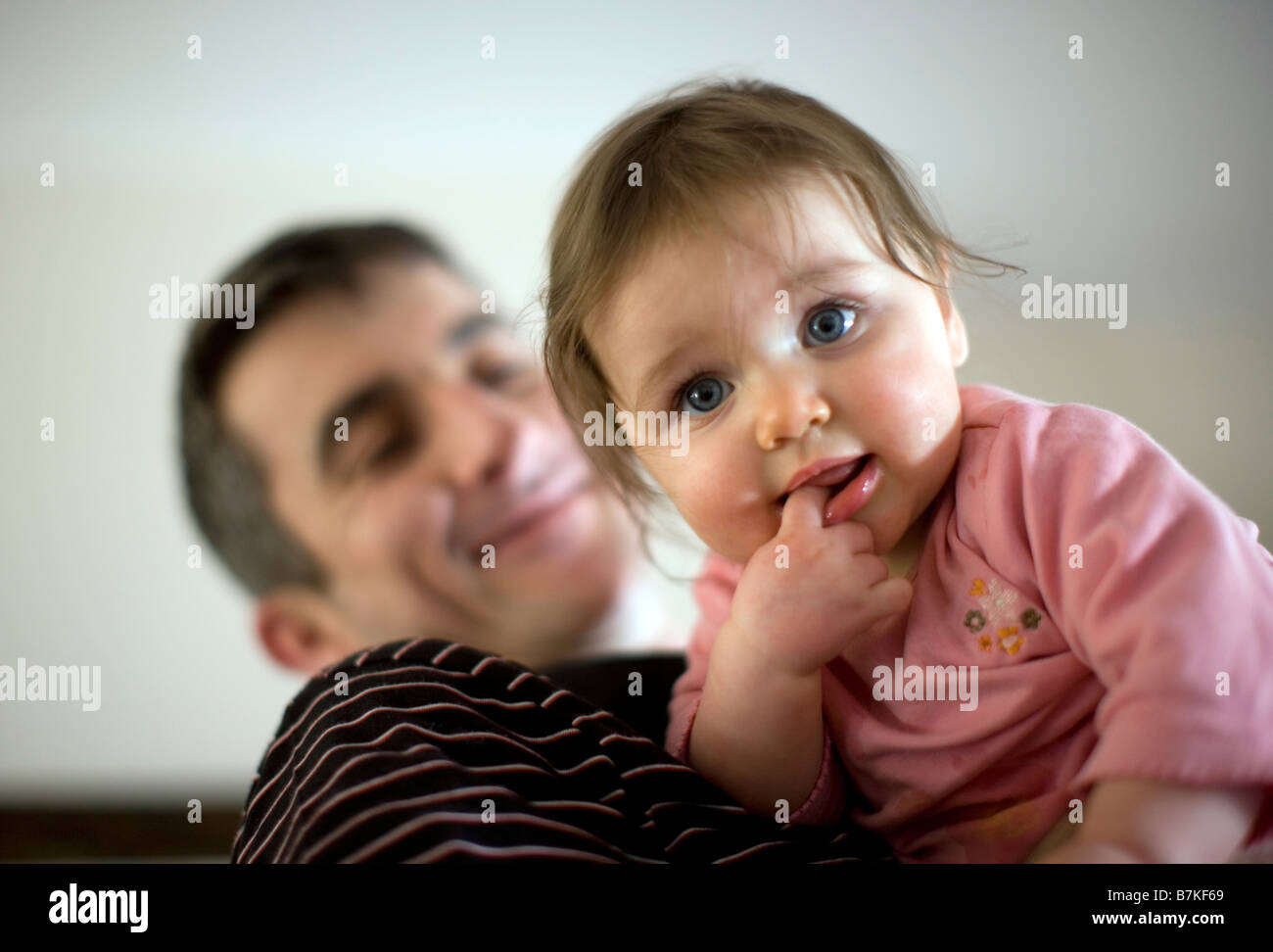A proud father looks at his baby daughter Stock Photo - Alamy