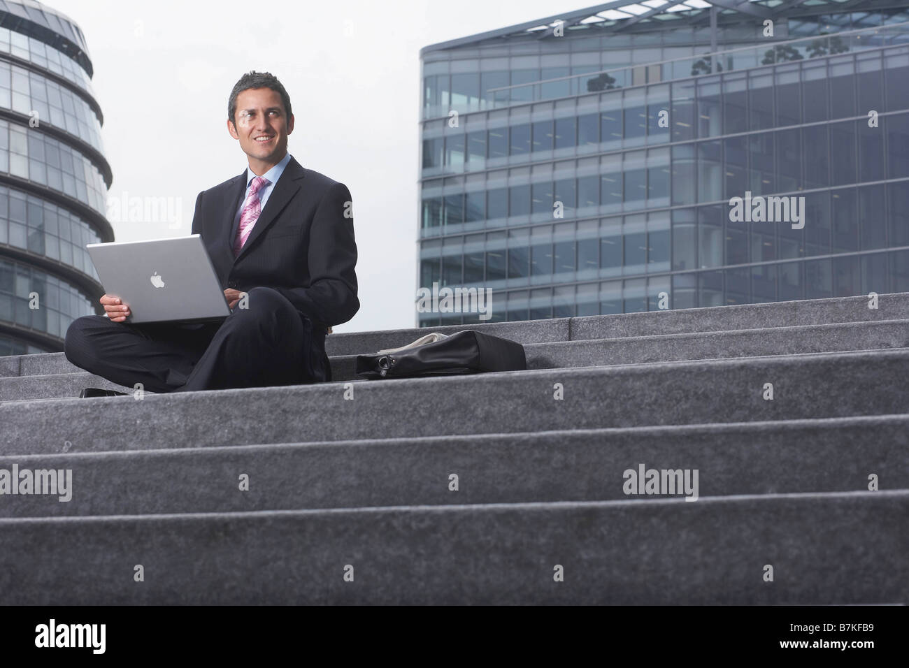 Business man with laptop outside Stock Photo - Alamy