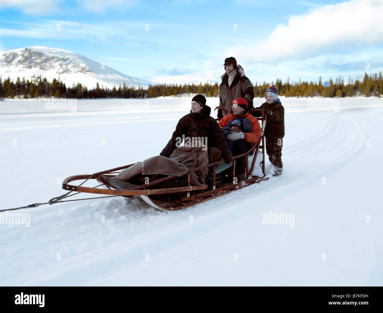 Family on sledge Stock Photo - Alamy