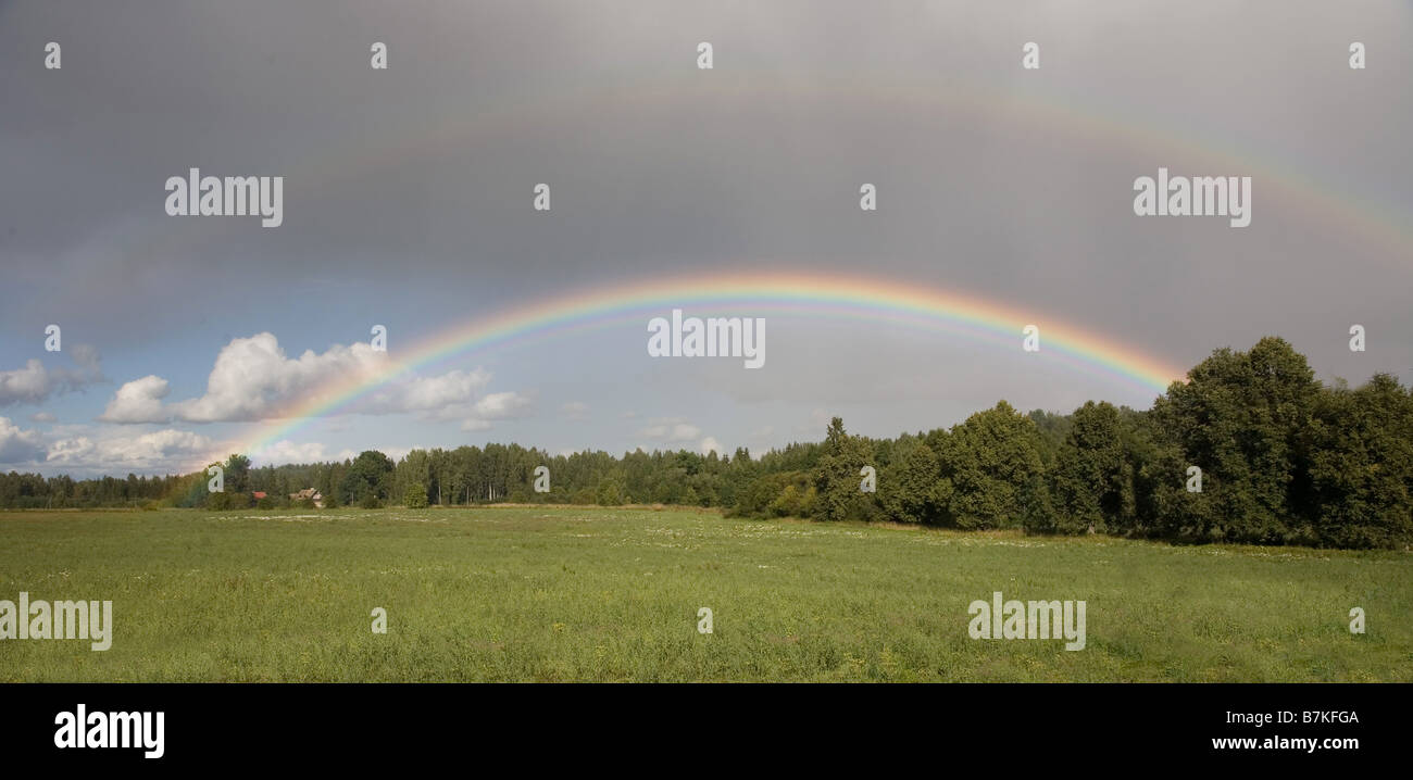 Rainbow Over Field Stock Photo - Alamy