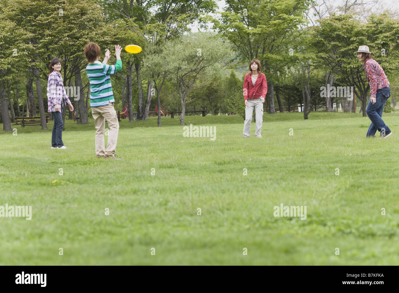 Group of Young People Playing Frisbee Stock Photo - Alamy