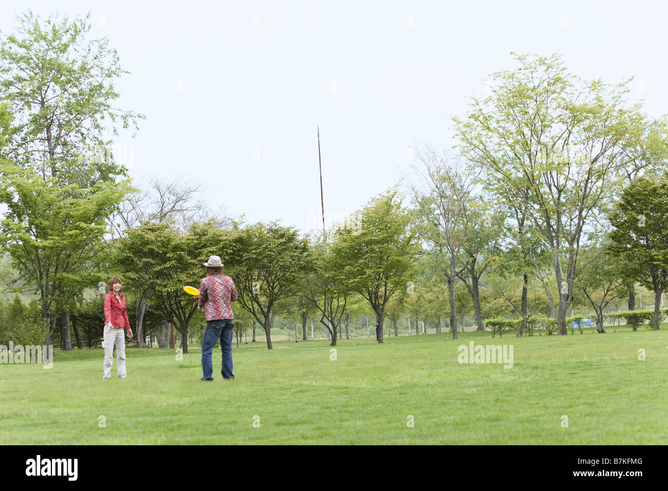 Playing frisbee lawn playground hi-res stock photography and images - Alamy