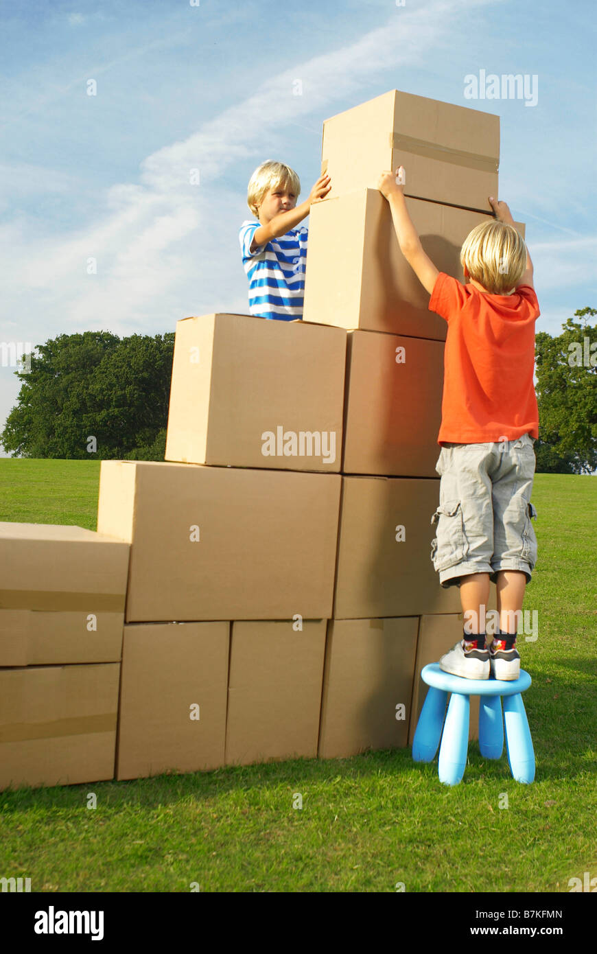 boys putting box on top of steps Stock Photo - Alamy