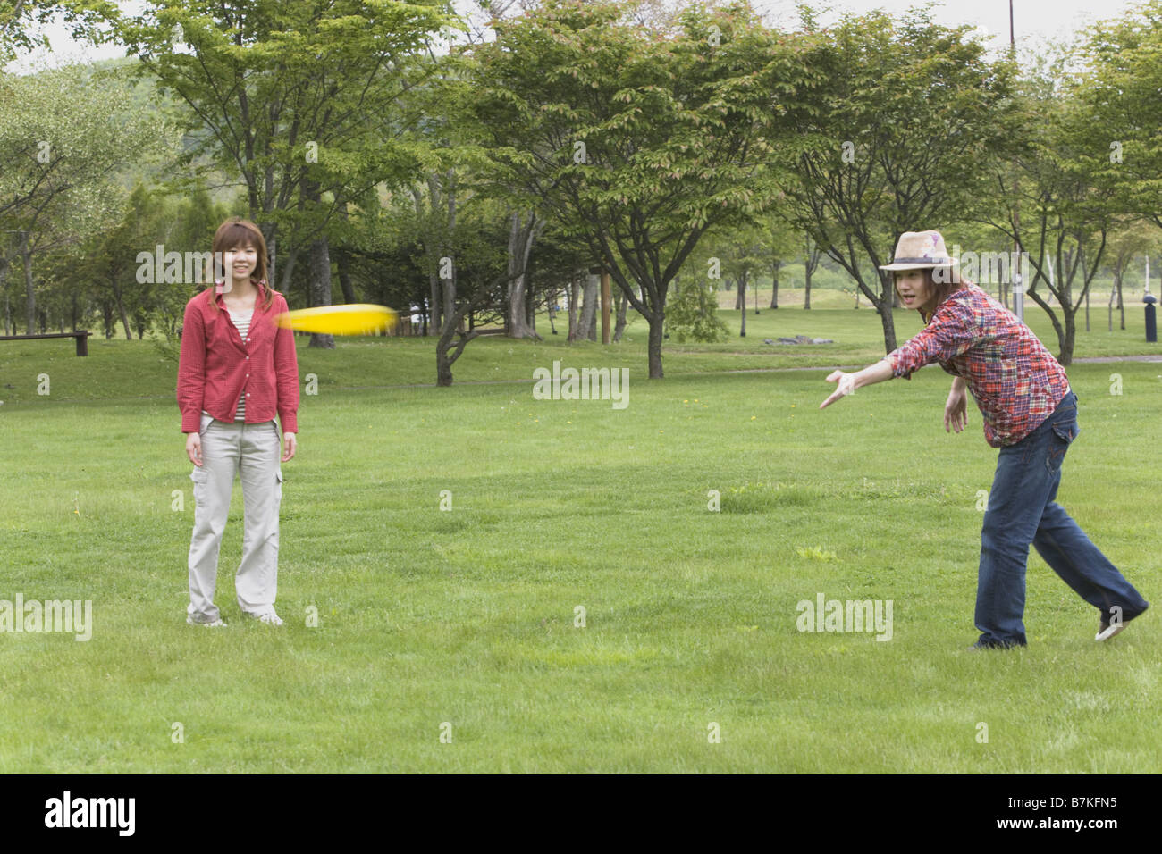 Young People Playing Frisbee Stock Photo - Alamy