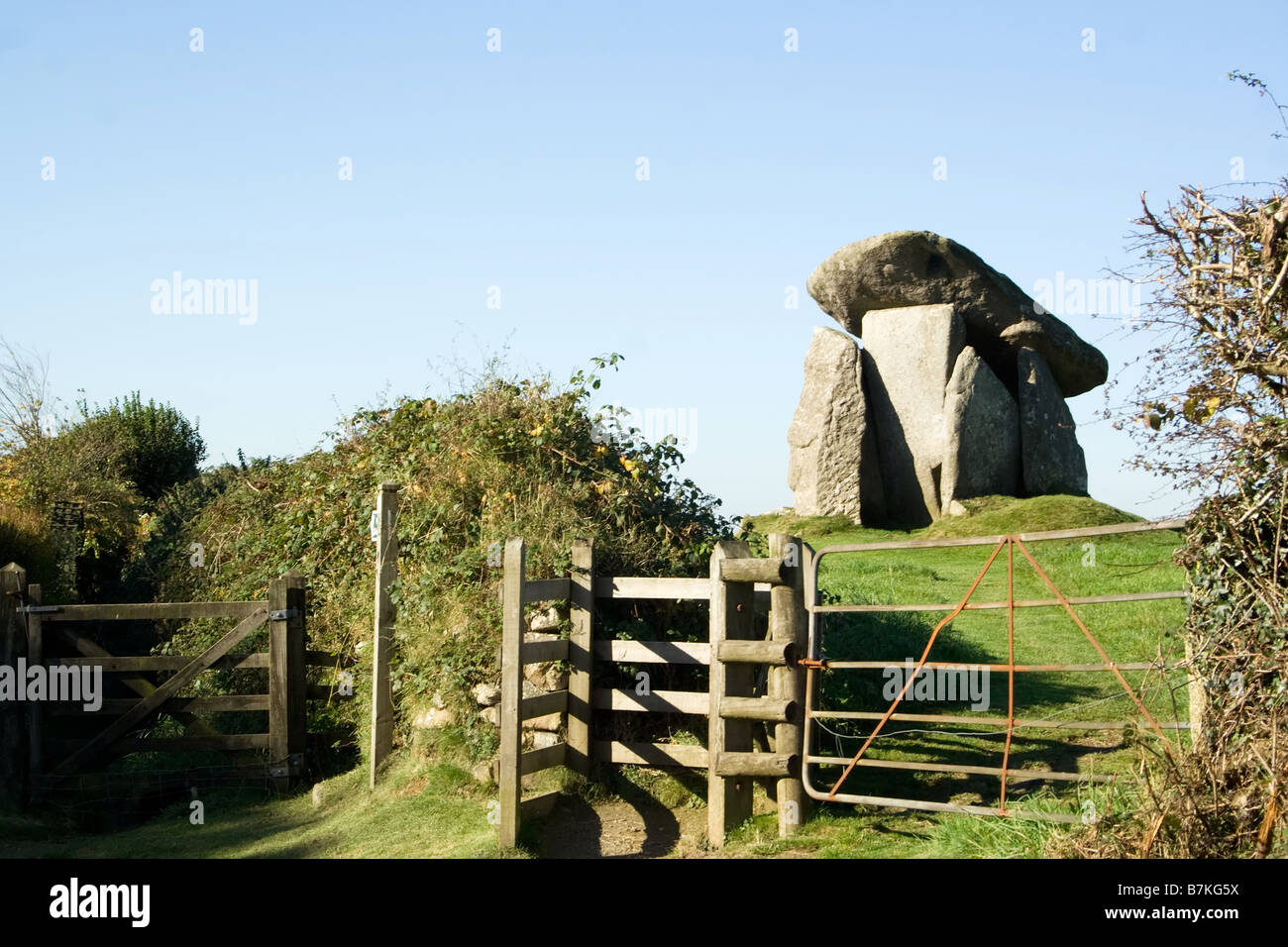 ancient stone monument in grass field with blue sky Stock Photo - Alamy