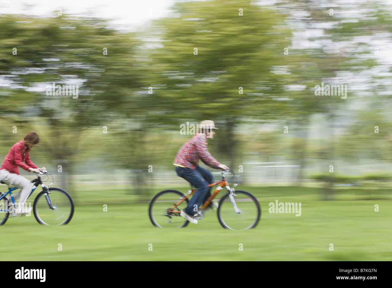 Couple Biking Together Stock Photo - Alamy