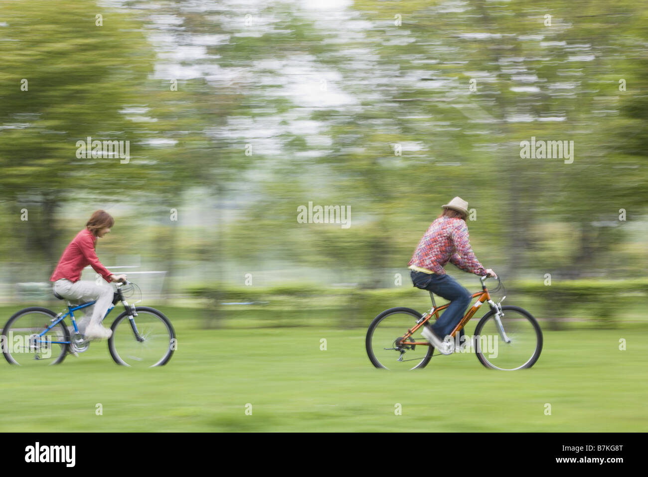 Couple Biking Together Stock Photo - Alamy