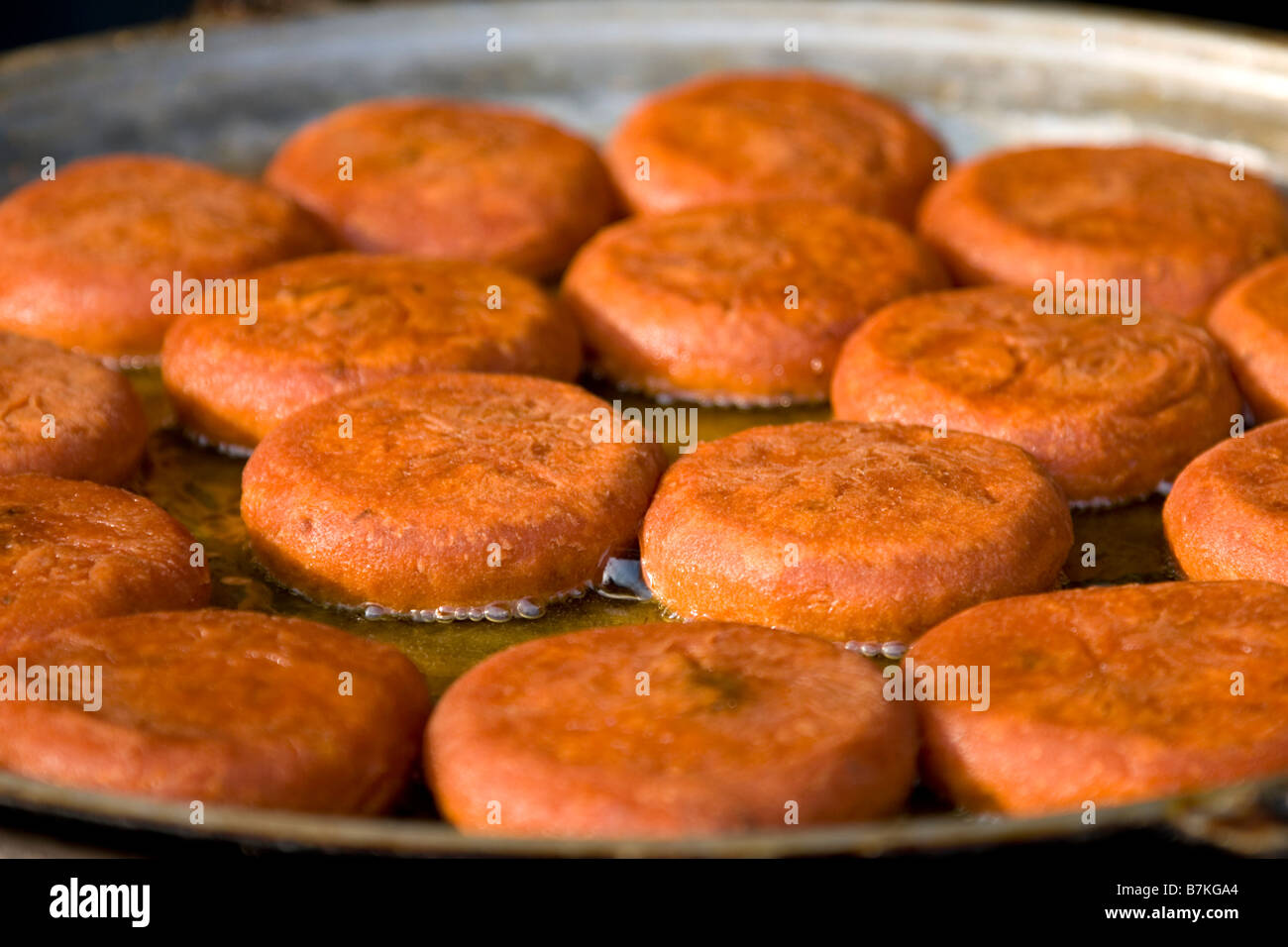 Traditional Hui Muslim cakes being fried in oil at an eatery in Xian in ...