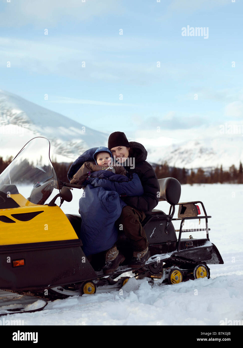 Mother and baby on Snowmobile Stock Photo - Alamy