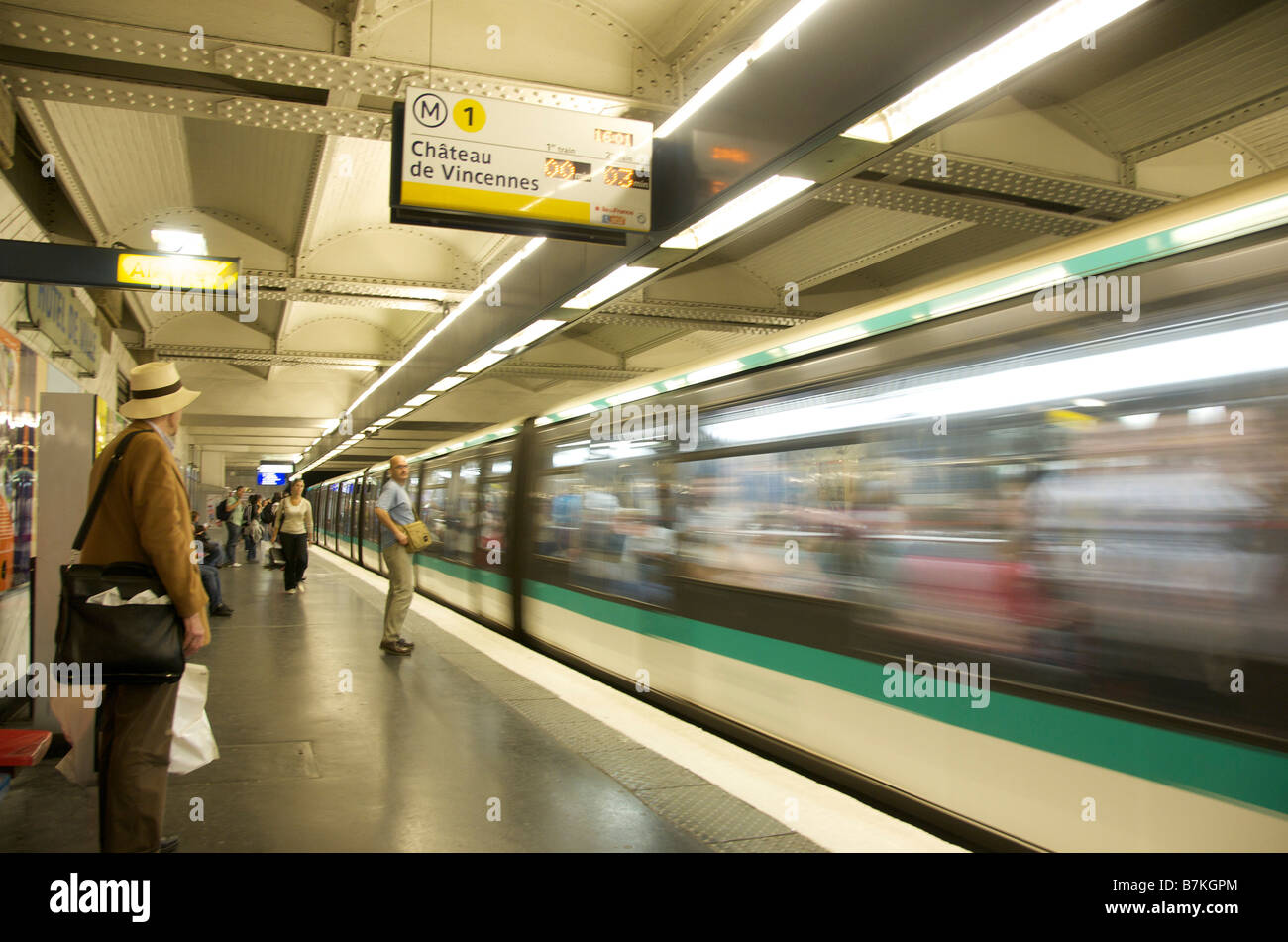 Train at Paris metro platform with passengers waiting, Paris, France ...
