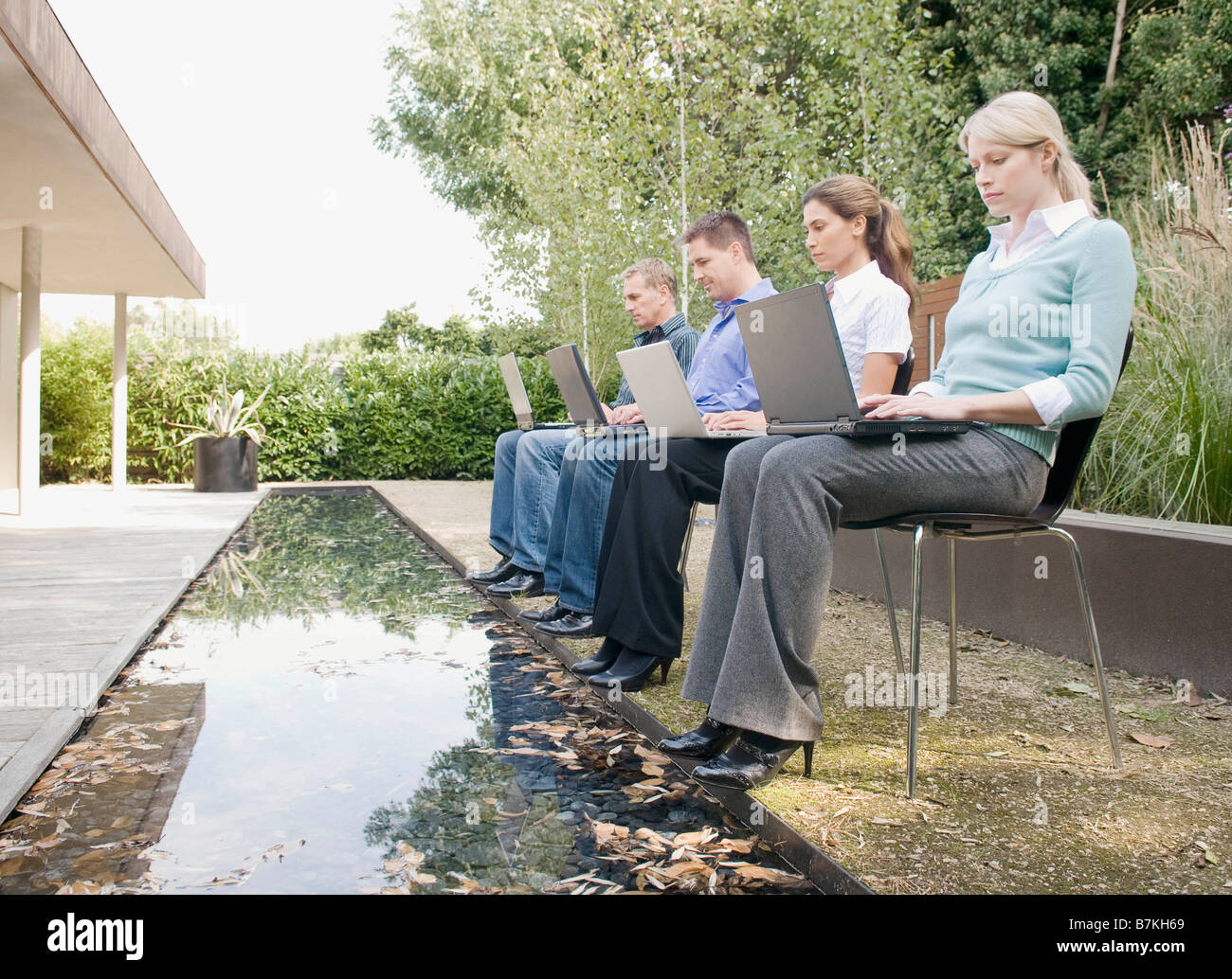 Four business people working outside Stock Photo - Alamy
