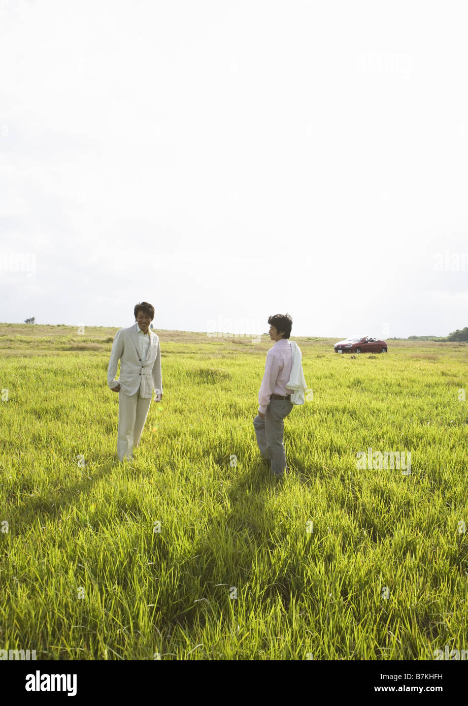 Two men in a field of grass Stock Photo - Alamy