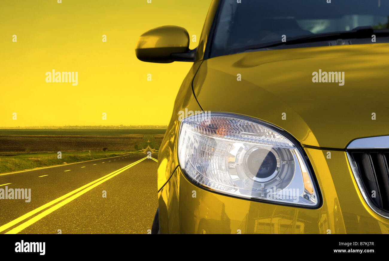 Yellow car on the road Stock Photo - Alamy