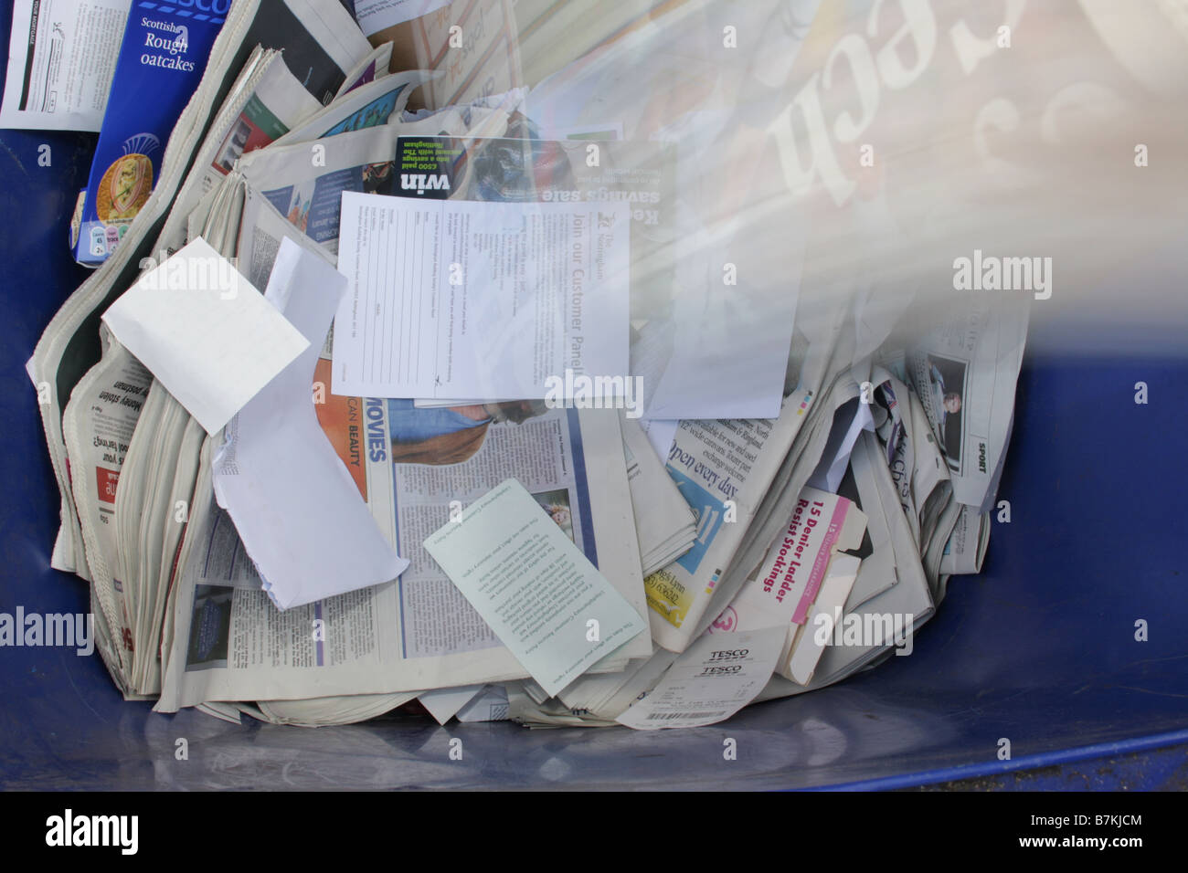 waste paper falling into recycle bin Stock Photo - Alamy