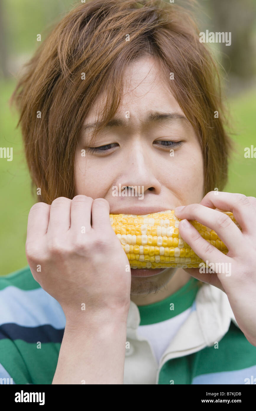 Man Eating a Boiled Corn Stock Photo - Alamy