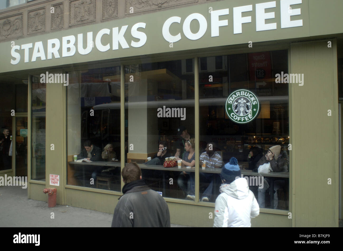 Starbucks customers enjoy their coffee in a Starbucks coffee shop in ...