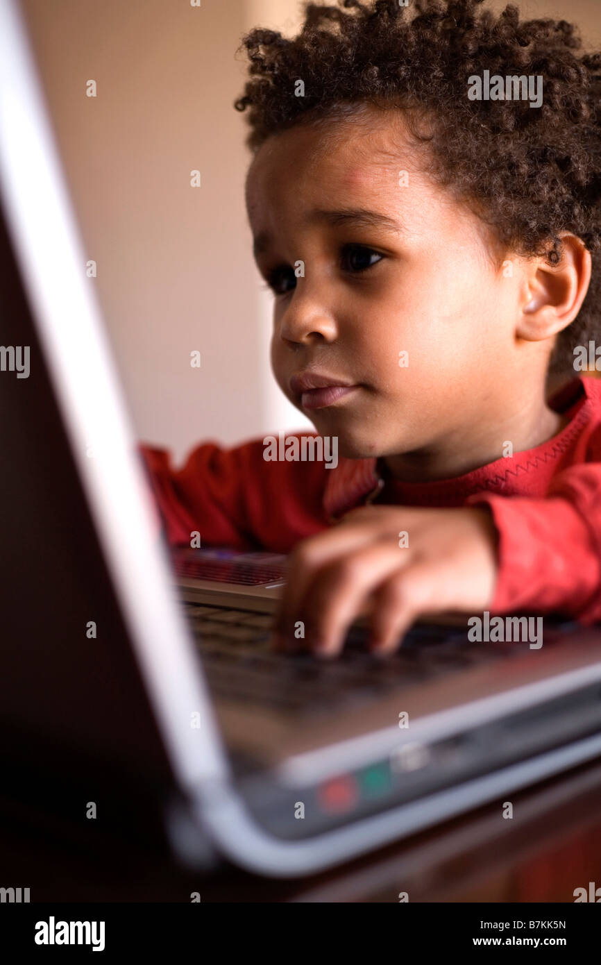 sitting little boy using laptop computer Stock Photo - Alamy