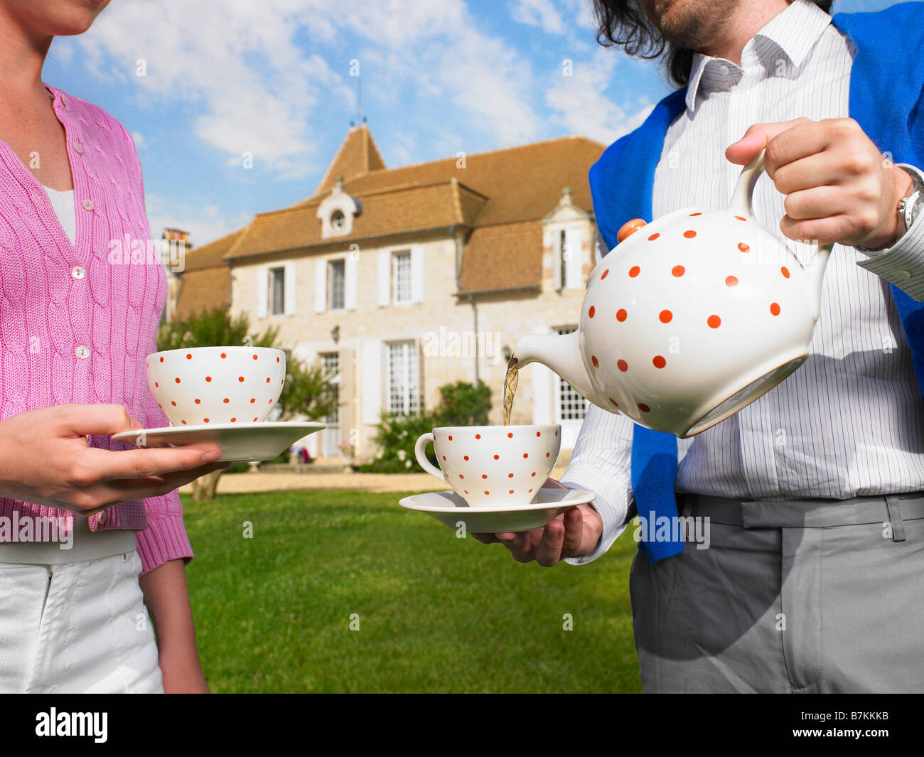 Drinking tea in front of country home Stock Photo - Alamy