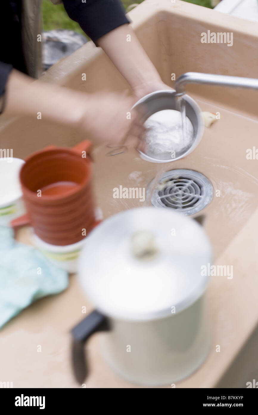 Woman washing utensils hi-res stock photography and images - Alamy