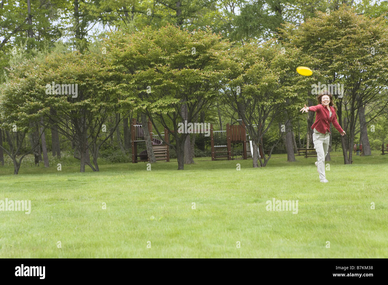 Woman Throwing a Frisbee Stock Photo - Alamy